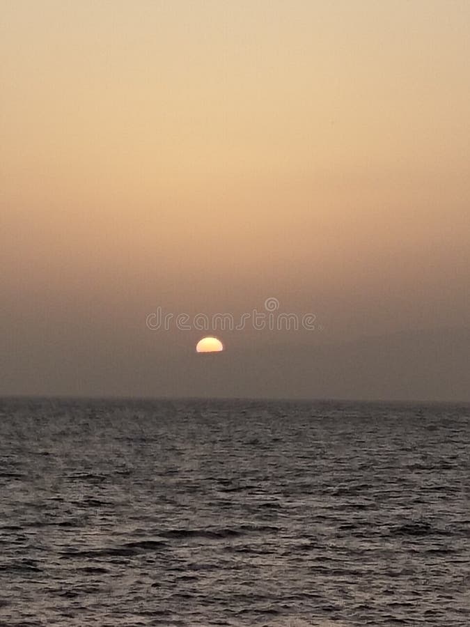 Watch the sunset beache stock photo. Image of dawn, wave - 241598830