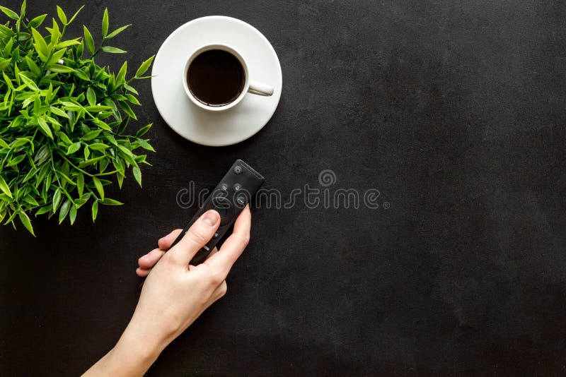 Watch TV Concept. TV Remote in Hand on Black Background Top-down Copy ...