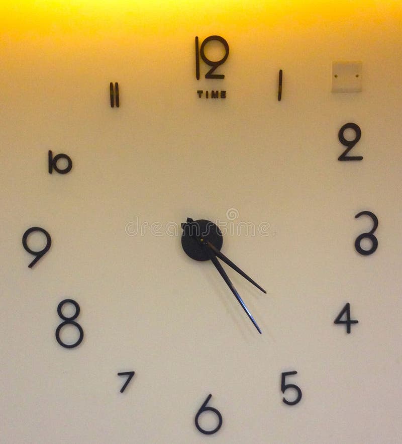 Watch on the white wall stock photo. Image of wall, white - 155186572