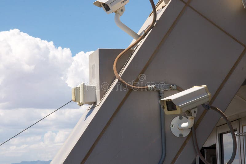 Security Cameras On Building Roof Stock Photo - Image of zoom, plain ...