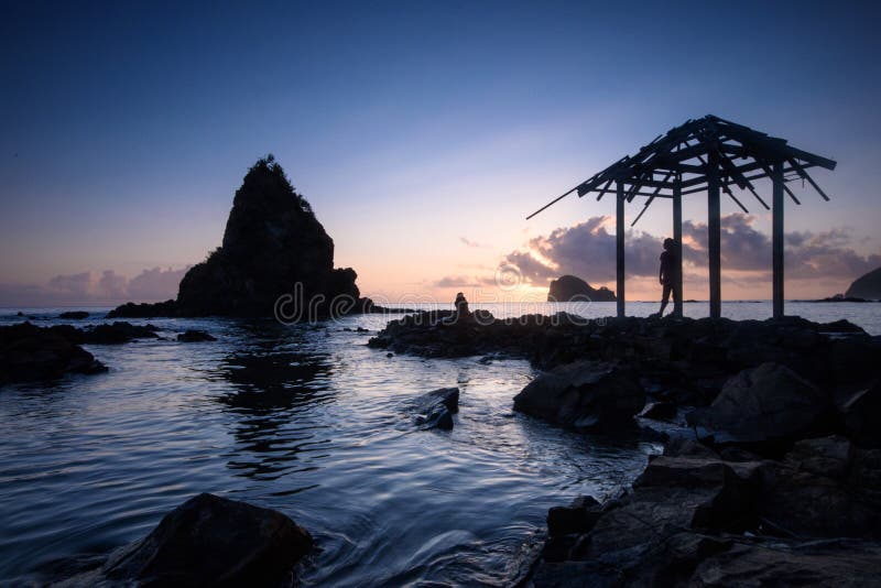 Watching Sunrise and Rock Formation at the Shore Editorial Stock Image ...