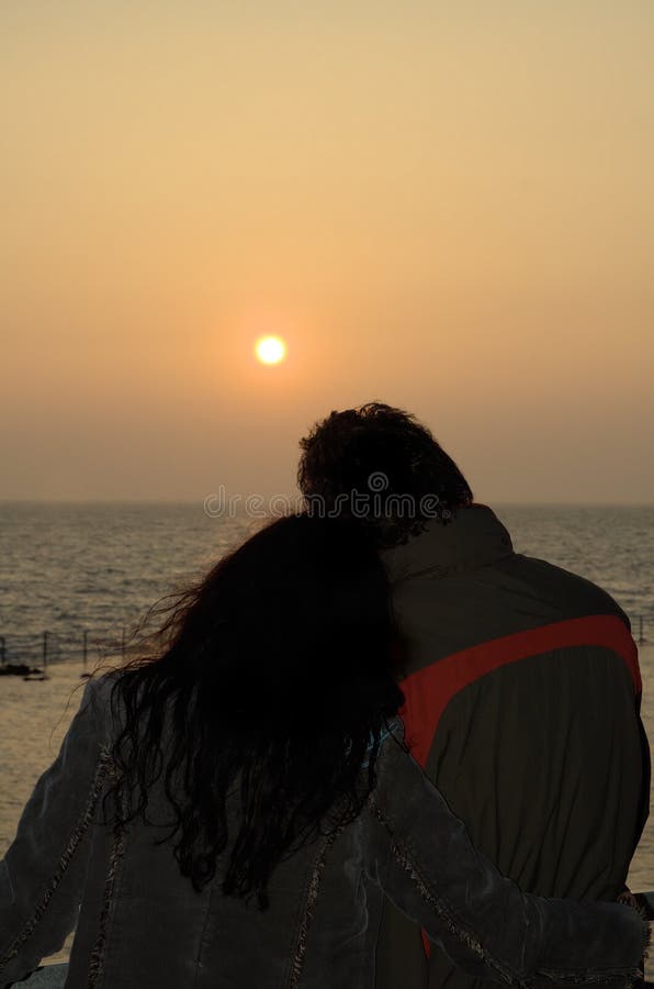 Watching the sunset stock photo. Image of reflection, couple - 2406114