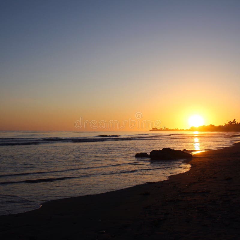 Watching the Sunset at the Beach Stock Photo - Image of sunset, beach ...