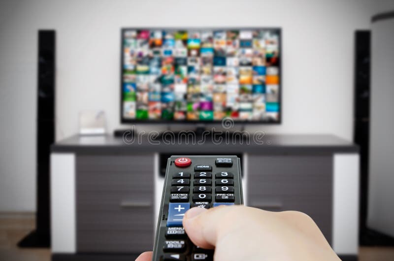 Watching Television in Modern TV Room. Hand Holding Remote Stock Photo ...