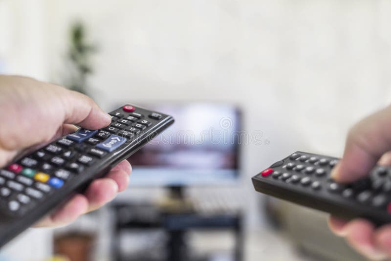 Watching Tv and Using Two Remote Control Stock Photo - Image of digital ...