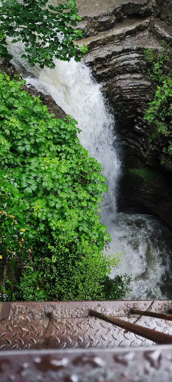 Watching the Waterfall from the Iron Bridge in the Forest Stock Image ...