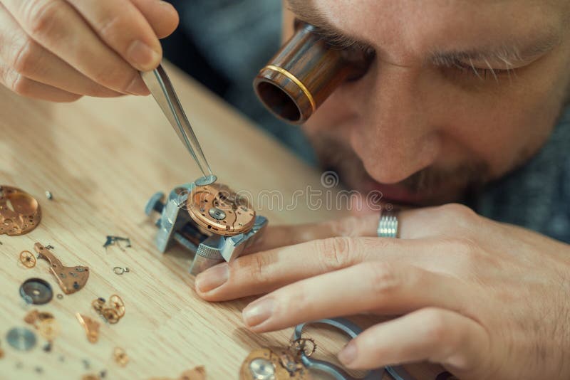 Watchmaker at work stock image. Image of holding, metal - 74921055