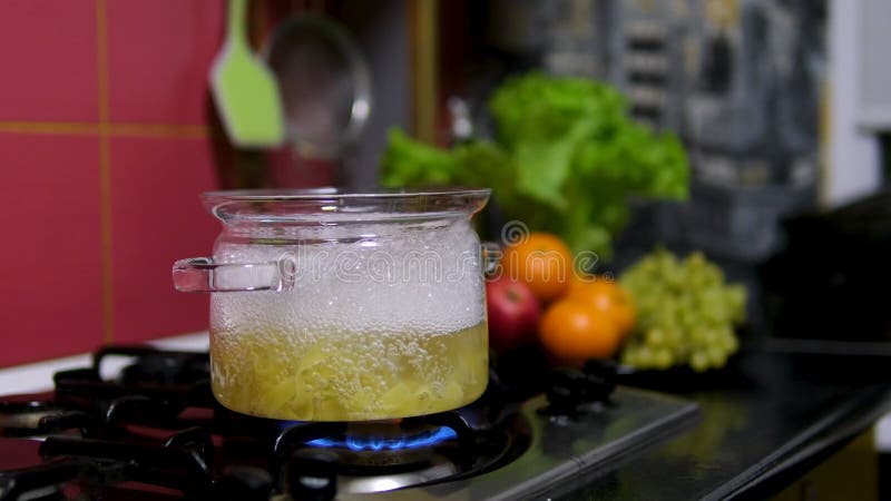Water Boiling in Pot Over Stove with Pasta. Close Up of Boiling Bubbles ...