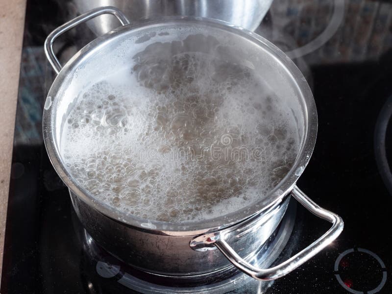 Water Boils in Steel Pan on Ceramic Stove at Home Stock Photo - Image ...