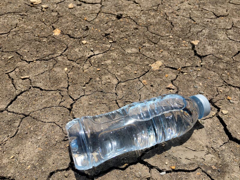 Water Bottle on Dry and Cracked Ground Stock Photo - Image of drought ...