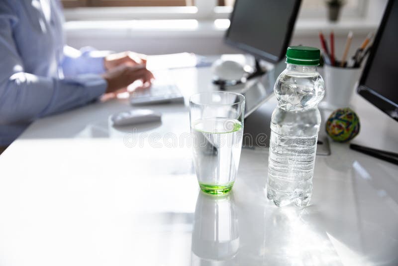 Water Bottle and Glass on Desk Stock Photo - Image of typing, glass ...