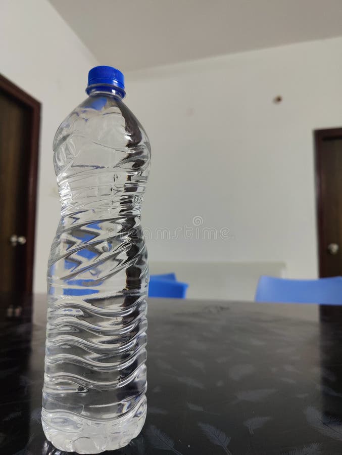 Water bottle on a table stock photo. Image of table - 251700926