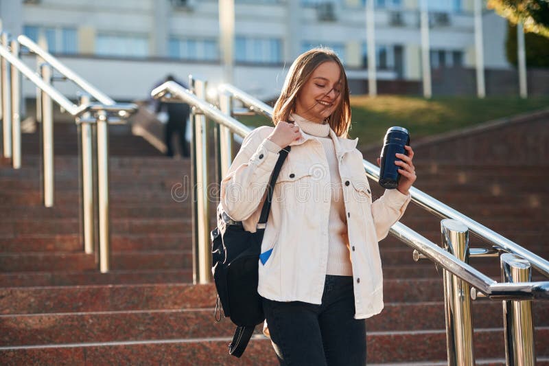 With Water Bottle. Young Female Student in Casual Clothes is Outdoors ...