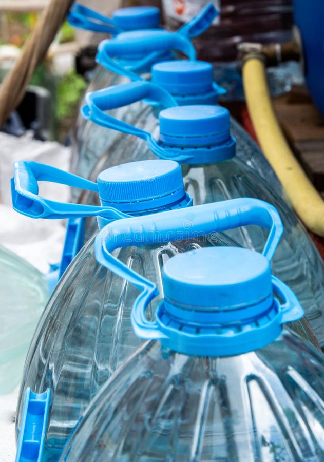 Water bottles in a row. stock photo. Image of heavy - 161293930