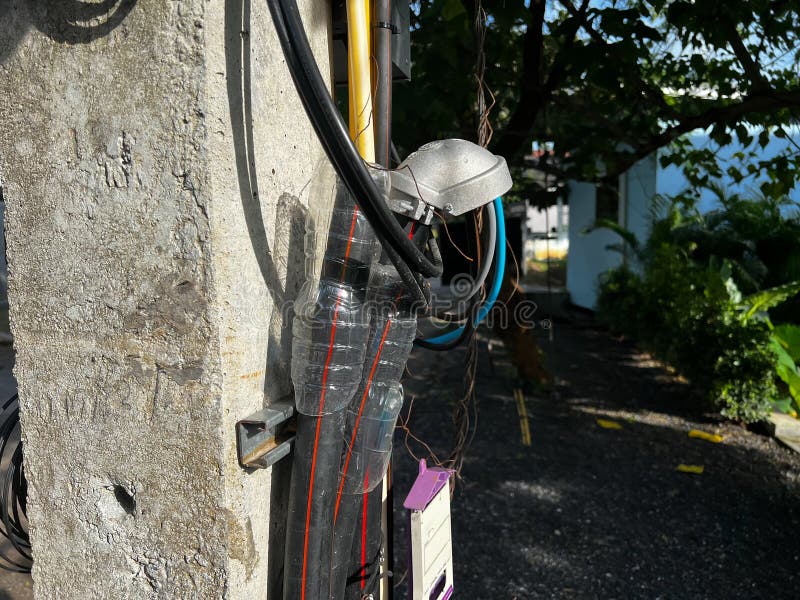 Water Bottles Used As Makeshift Electrical Wire Protection on a Utility ...