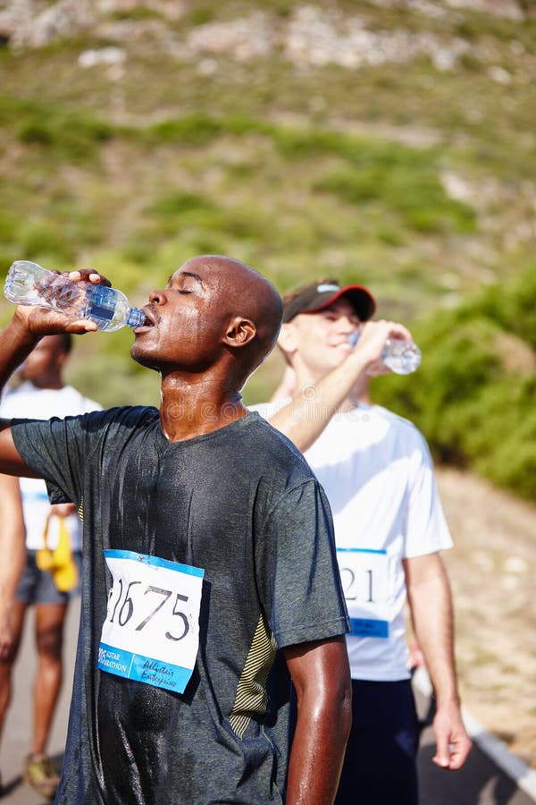 Water Break, Bros. a Group of Young Runners Catching Their Breath and ...