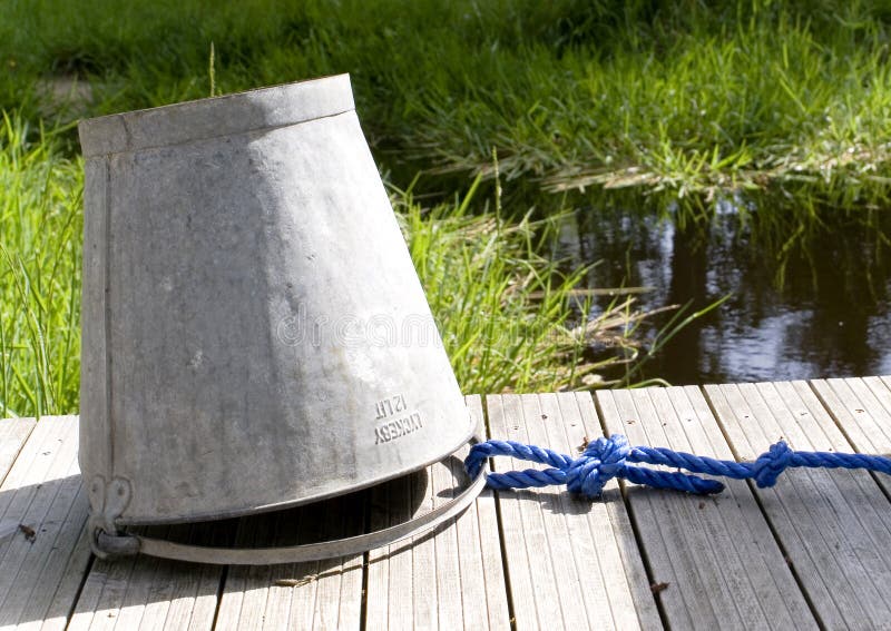 Water bucket on the bridge stock image. Image of summer - 5405395