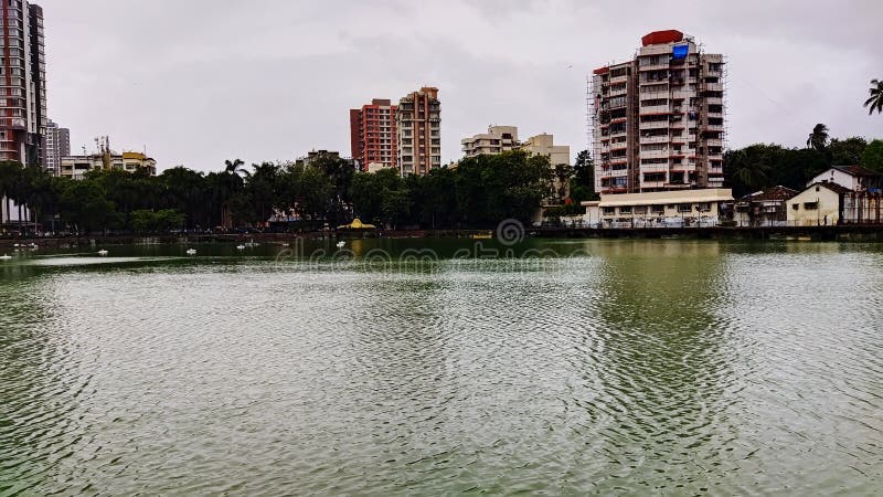 Water Building Trees Sky Clouds Stock Photo - Image of building, trees ...