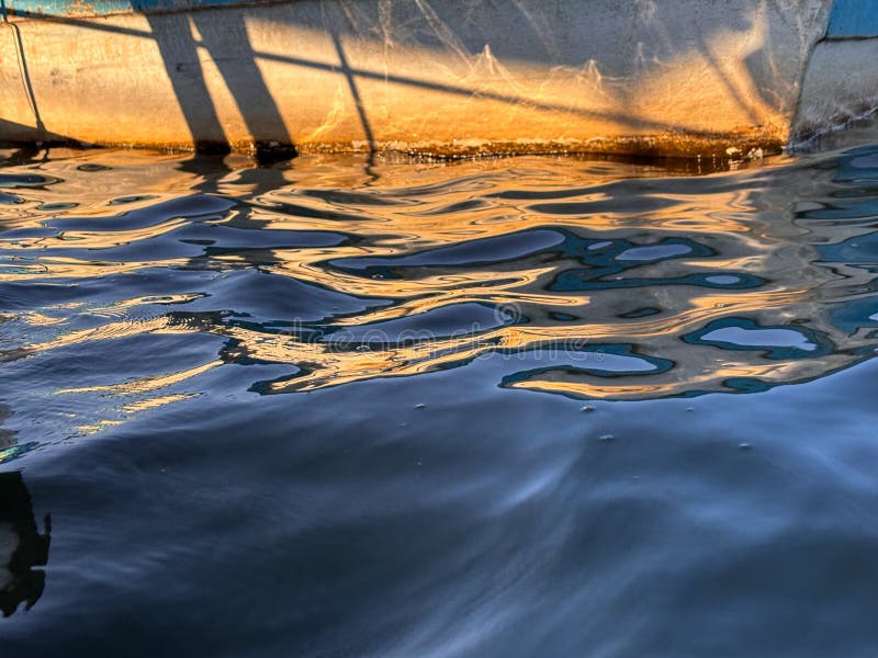The Water is Calm and the Reflection of the Boat is Visible Stock Image ...