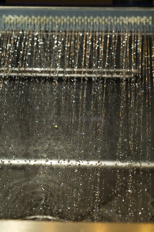 Water Cascading Down a Metallic Surface in a Modern Kitchen Setting ...