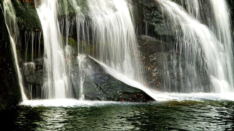Water Cascading Over a Triangular Black Rock in a Waterfall in the ...