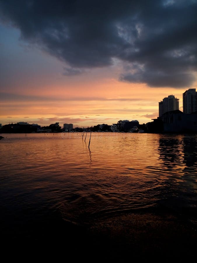 Water and Clowdy Afternoon Sky Stock Image - Image of clowdy, tand ...