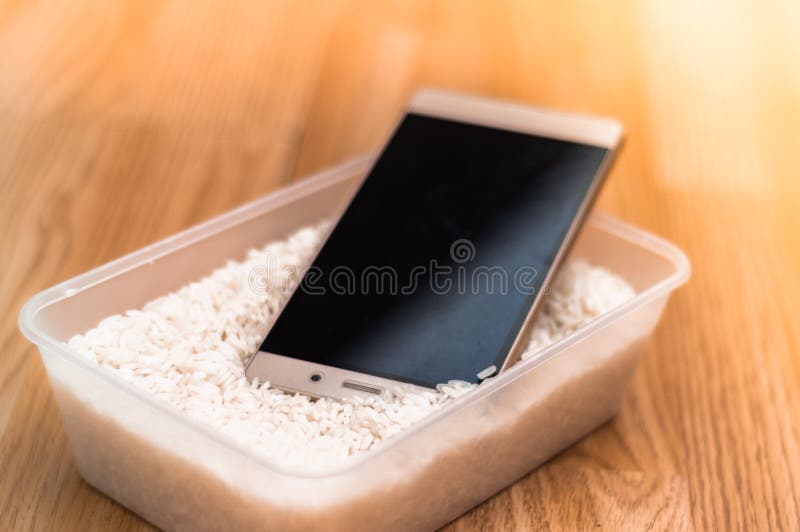 Water Damaged Phone in Rice Stock Image - Image of resusciating, tips ...