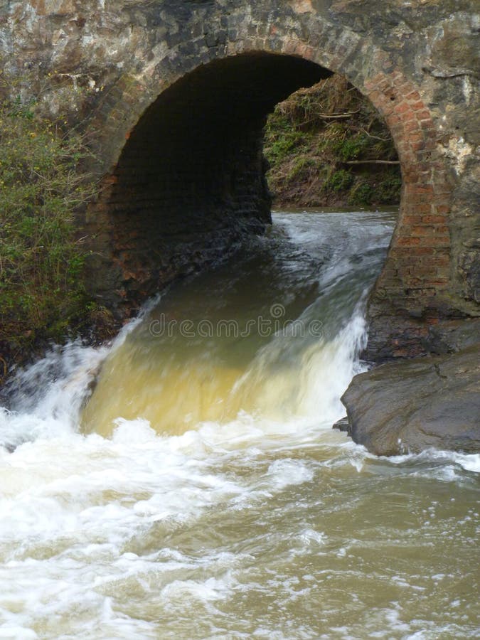 Water discharge stock photo. Image of foam, river, bridge - 85771776
