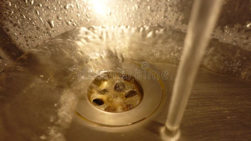Water Drains into Sink while Bubbles Rise from the Surface Stock Video ...