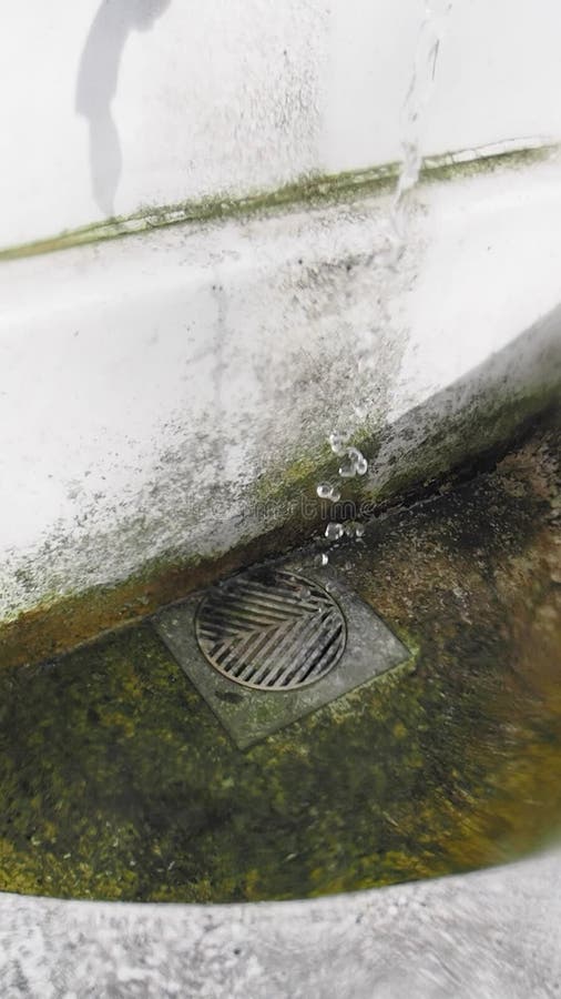 Water Droplets Falling into a Drain in a Wet Environment Stock Footage ...