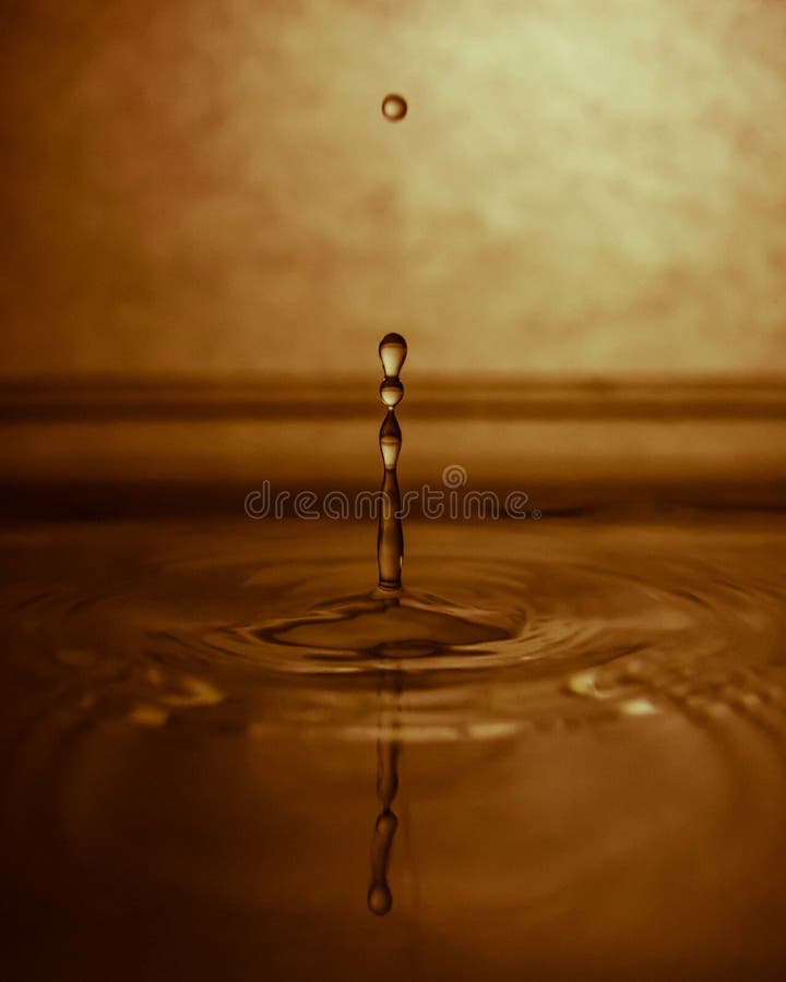 Water Dripping and Splashing with a Yellow Effect Stock Photo - Image ...