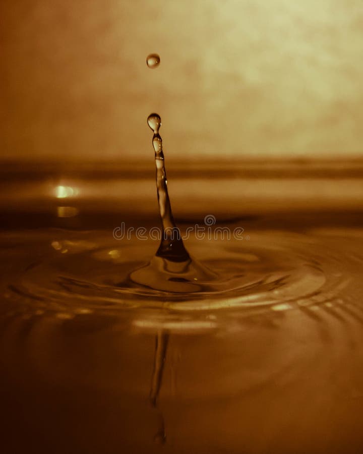 Water Dripping and Splashing with a Yellow Effect Stock Image - Image ...