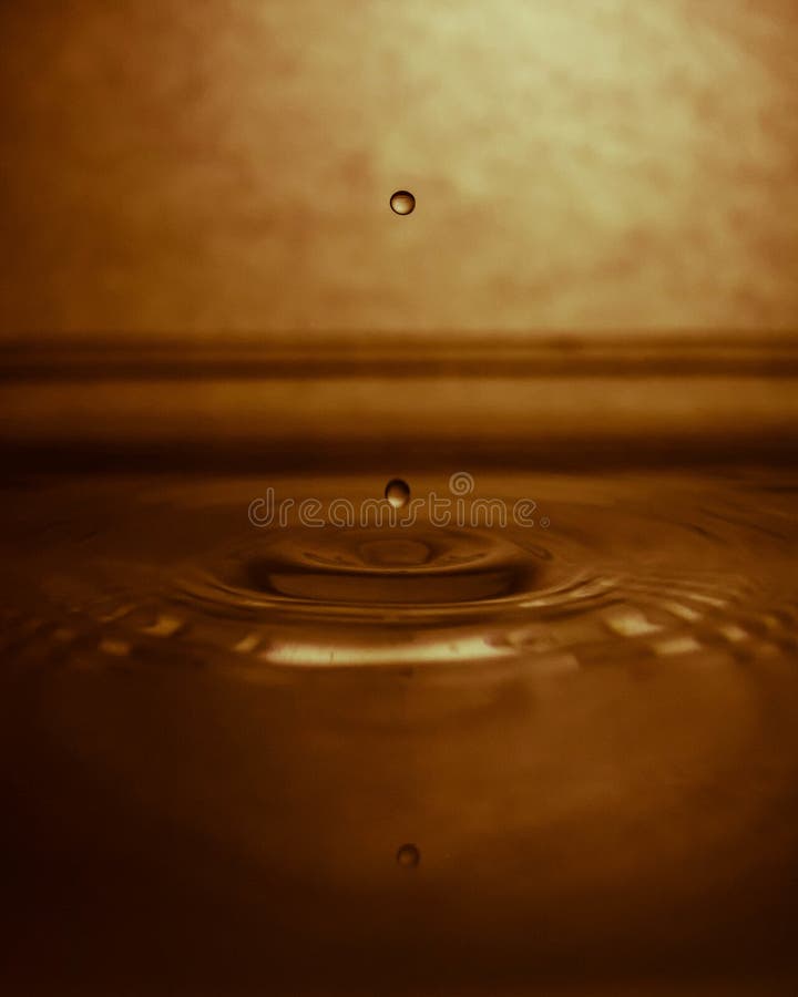 Water Dripping and Splashing with a Yellow Effect Stock Image - Image ...