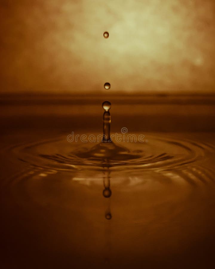 Water Dripping and Splashing with a Yellow Effect Stock Image - Image ...
