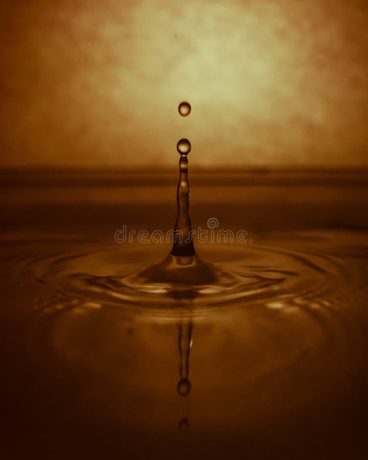 Water Dripping and Splashing with a Yellow Effect Stock Photo - Image ...