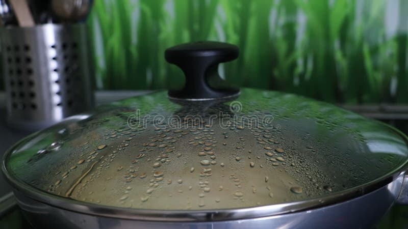 Water Drips Down the Glass Lid of the Pan while Cooking. Stock Footage ...