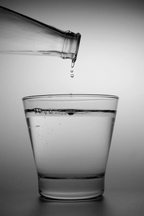 Water Drop from the Bottle To the Small Glass Stock Image - Image of ...