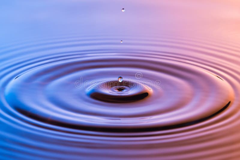 Water Drop Close Up with Concentric Ripples Colourful Blue and a Stock ...