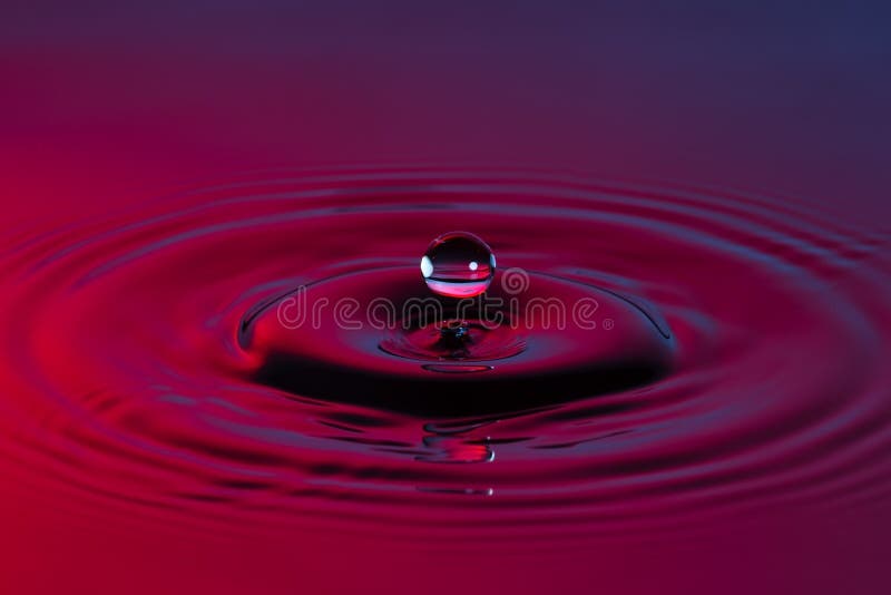 Water Drop Close Up with Concentric Ripples Colourful Blue and R Stock ...