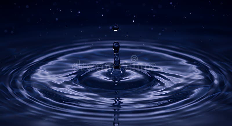 Water Drop Creating Ripple Effect with Reflection in Dark Blue Stock ...