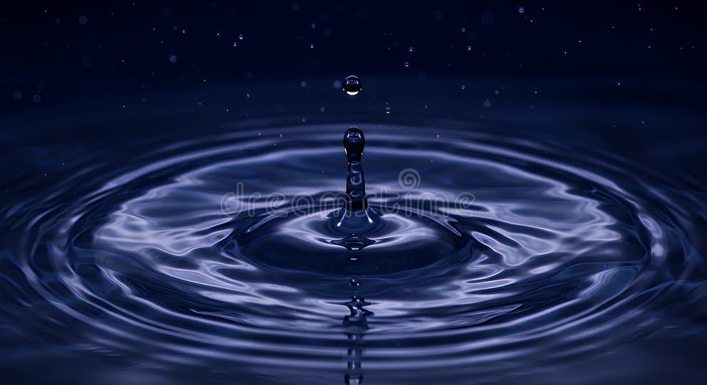 Water Drop Creating Ripple Effect with Reflection in Dark Blue Stock ...