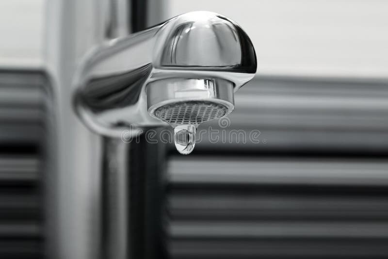Water Drop Falling Down from Tap in Bathroom, Closeup Stock Photo ...