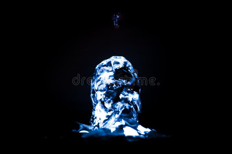 Water Drop Falling on Illuminated Water Flash Stock Photo - Image of ...