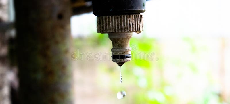 A Water Drop Falls from a Dirty and Rusty Water Tap - Water Engineering ...