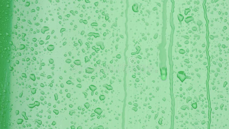 Water Drop Flowing on a Green Plastic Surface Stock Footage - Video of ...
