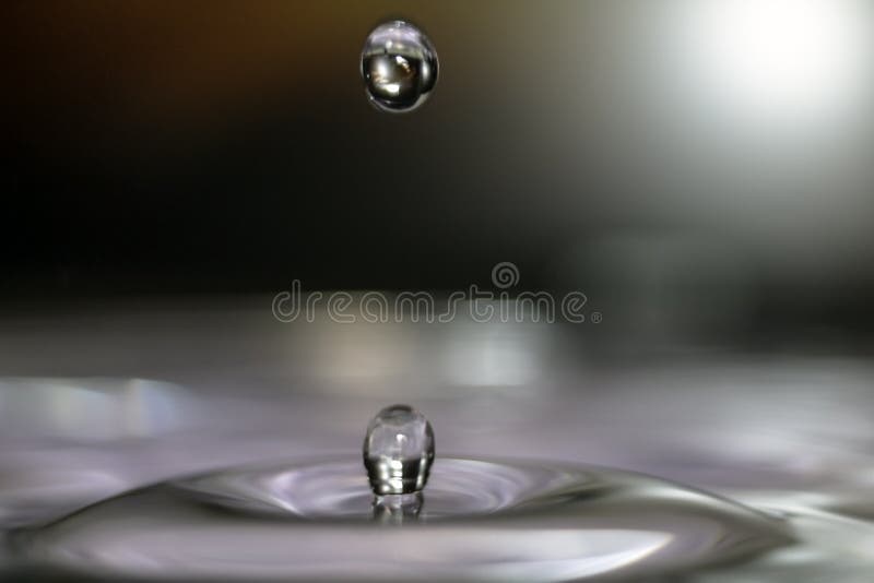 Water Drop Landing in a Puddle of Water Stock Photo - Image of color ...