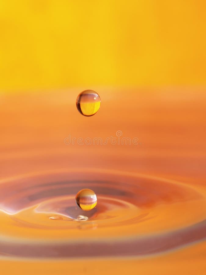 Orange water drop stock image. Image of light, moment, drip - 25799