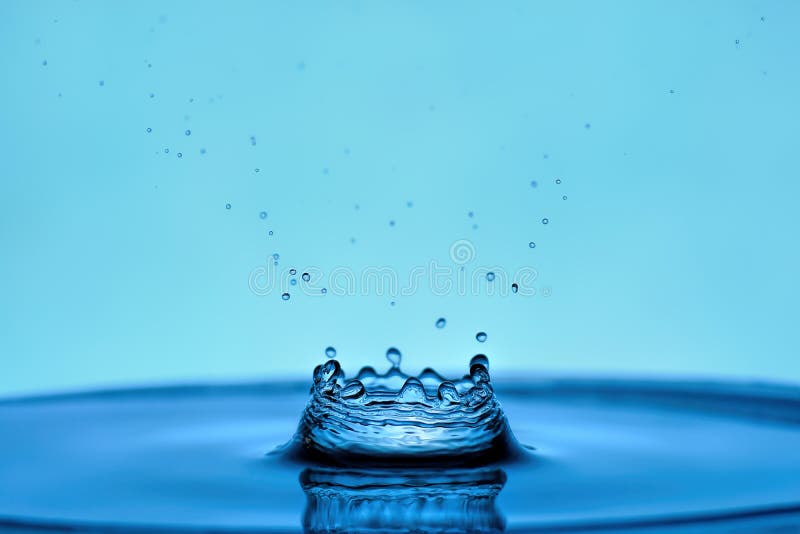 Water Drop Splash. Water Drop in Blue Background. Stock Photo - Image ...