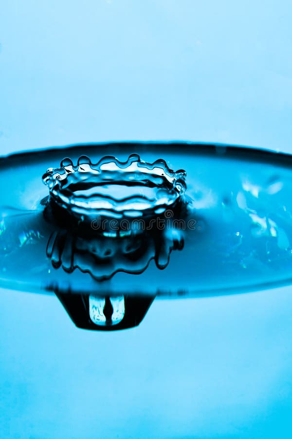 Water Drop Splash in a Glass Blue Colored Stock Image - Image of ...
