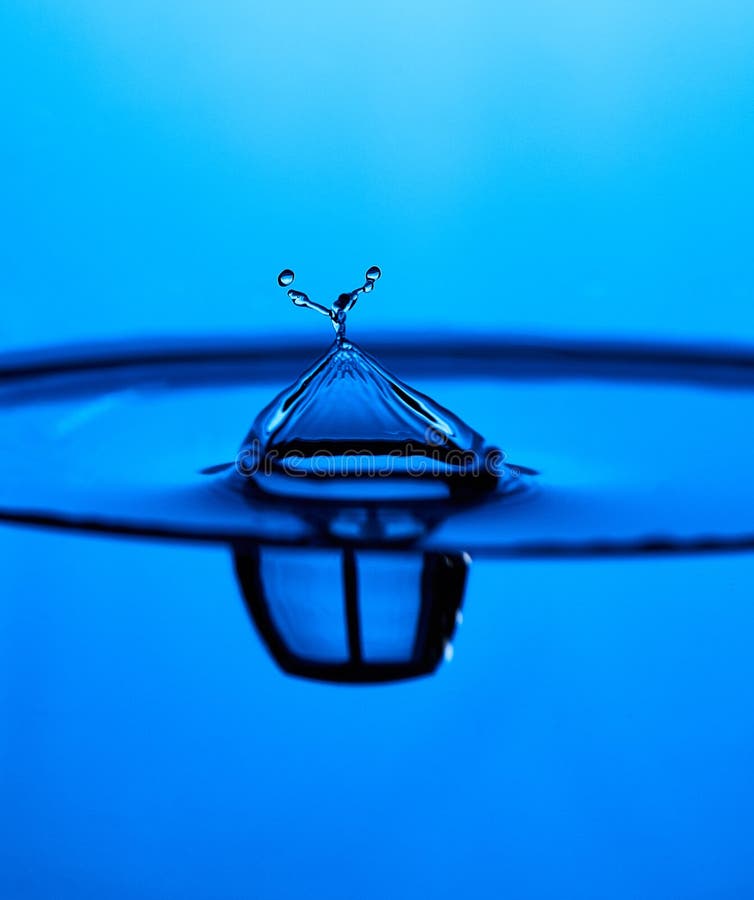 Water Drop Splash in a Glass Blue Colored Stock Image - Image of clear ...